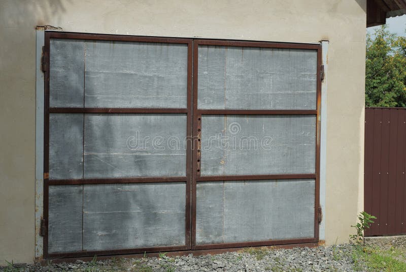 Gray Iron Gate on a Brown Concrete Wall Stock Photo - Image of modern ...