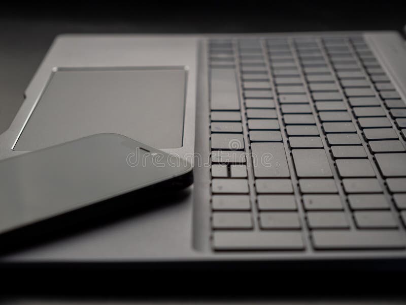 Gray Laptop Keyboard and Smartphone Close-up. Low Angle View of ...