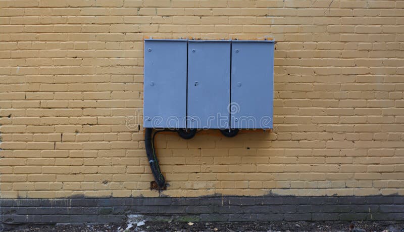Gray Metal Electrical Panel on a Yellow Brick Wall Stock Image - Image ...