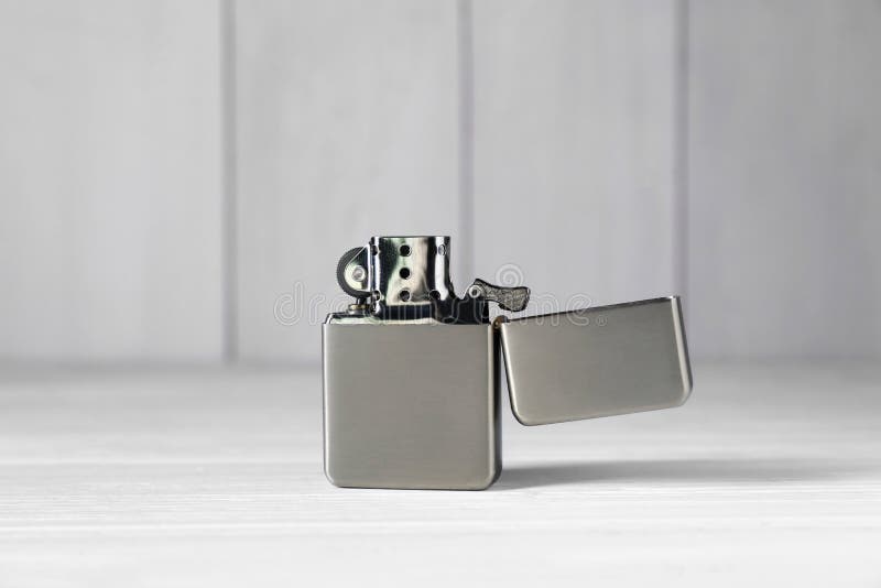 Gray Metallic Cigarette Lighter on White Wooden Table Stock Photo ...