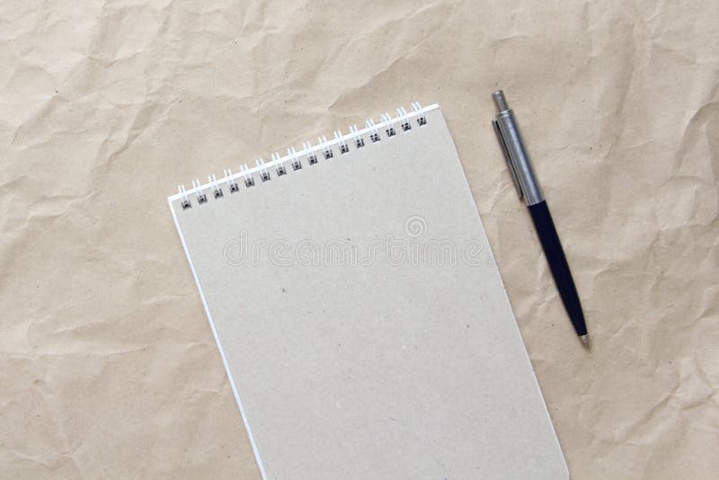 Gray Notepad with White Coiled Spring and Pen on a Background of Beige ...