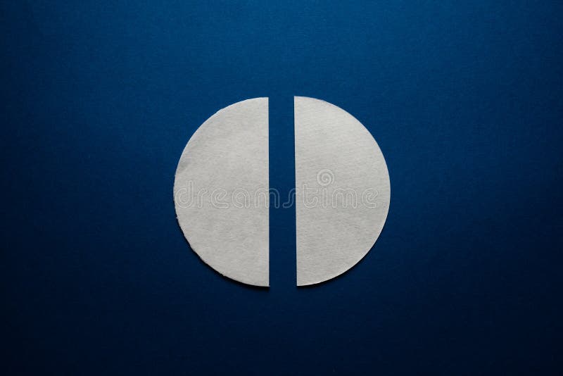 Two Gray Paper Circles are Cut into One Quarter on a Dark Blue ...