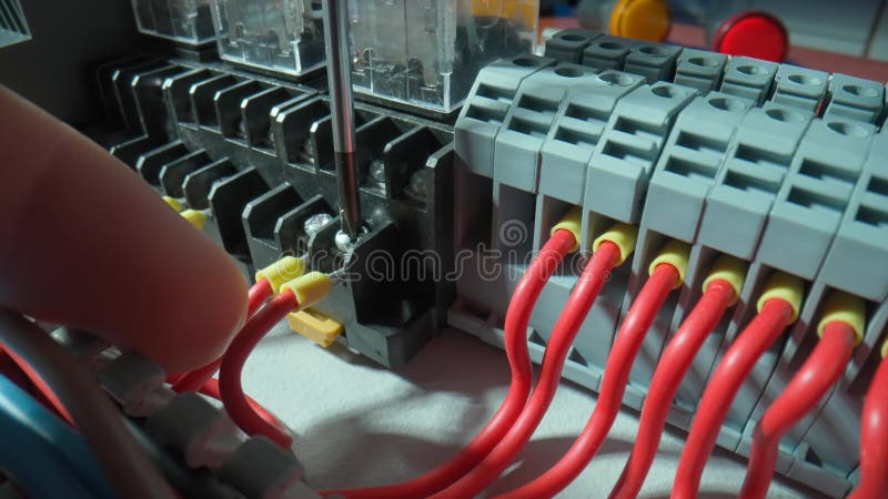 Gray Plastic Electrical Panel with Many Red Wires, Yellow Bushing ...