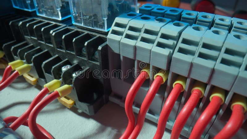 Gray Plastic Electrical Panel with Many Red Wires, Yellow Bushing ...