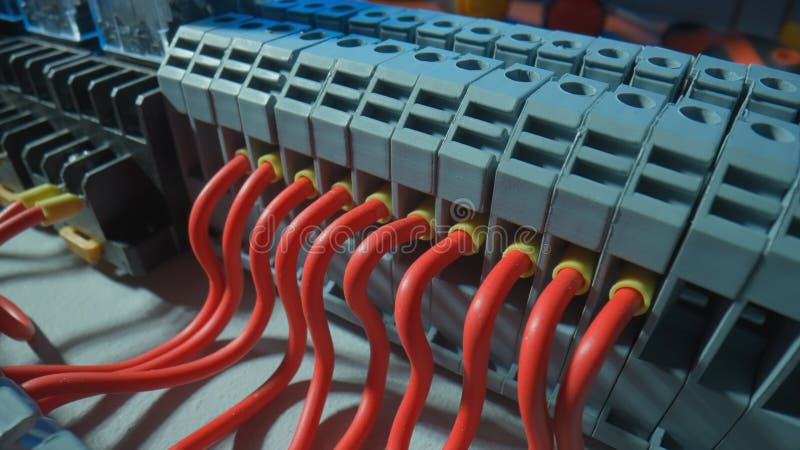 Gray Plastic Electrical Panel with Many Red Wires, Yellow Bushing ...