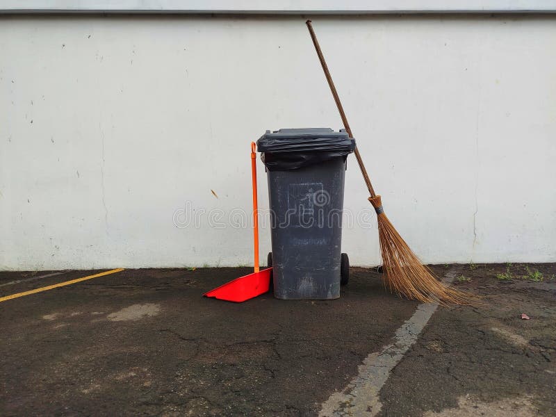 A Gray Plastic Trash Bin with a Black Plastic Bag Inside Stock Image ...
