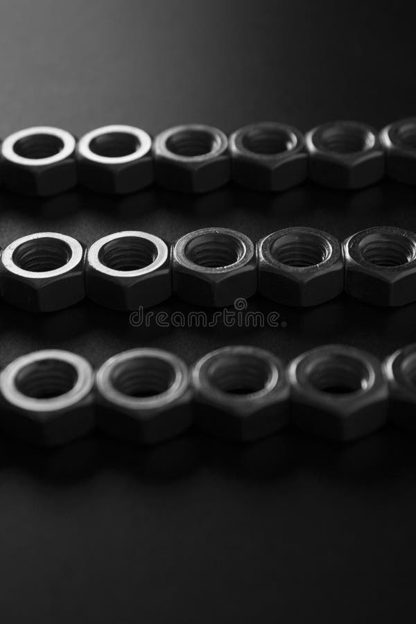 Screw-nuts on a Black Surface Stock Image - Image of black, screwnut ...