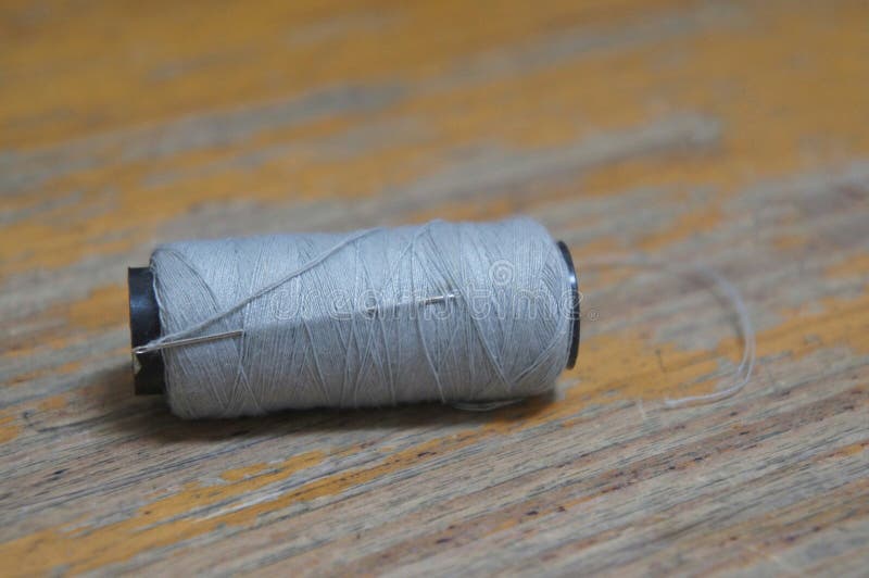 Gray Sewing Thread Roll Isolated on Wooden Table Background. Stock ...