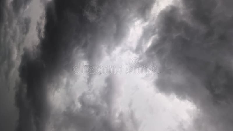 ,Gray Thunderclouds Drift Across the Sky, Occasionally Lit Up by ...