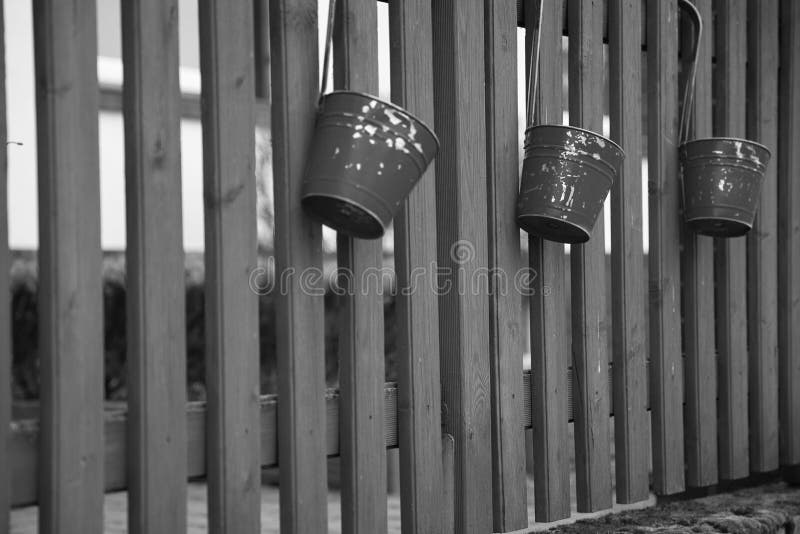 Grayscale of Buckets Hanging from a Wooden Fence Stock Image - Image of ...