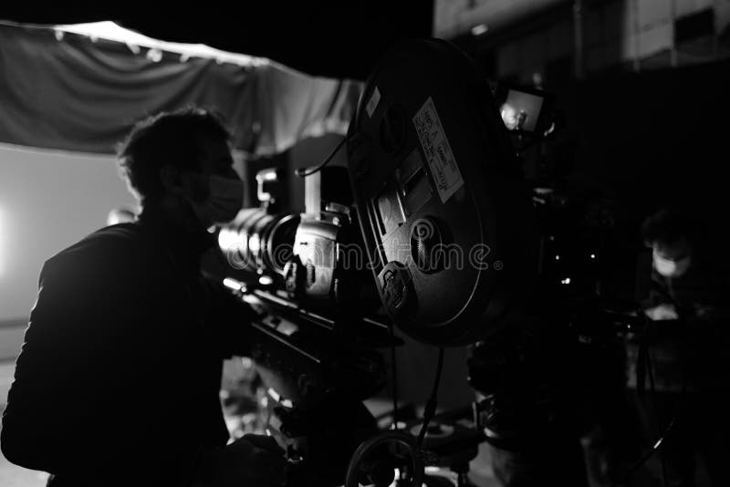 Grayscale of a Cameraman in a Mask Near the Camera Stock Image - Image ...