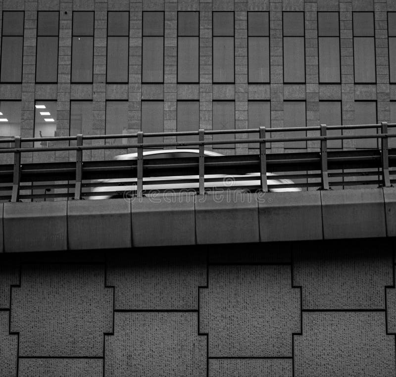 Grayscale of a Car Driving Fast on a Bridge Stock Image - Image of ...