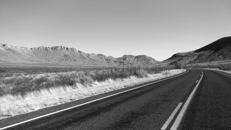 Grayscale of an Empty Countryside Road Surrounded by the Wide Field and ...