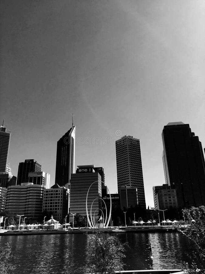 Grayscale High-rise Building Mirrored On Calm Body Of Water Picture ...