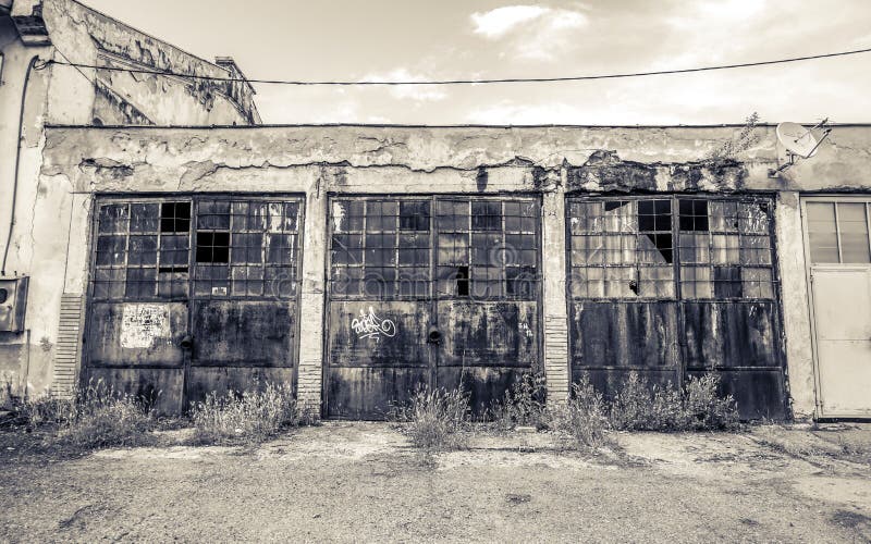 Grayscale of an Old, Wrecked Warehouse Building Against the Sky ...