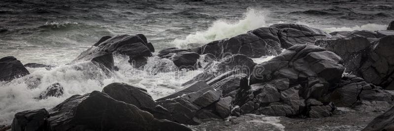 Grayscale Panoramic Shot of the Ocean Waves Reaching the Stones on the ...