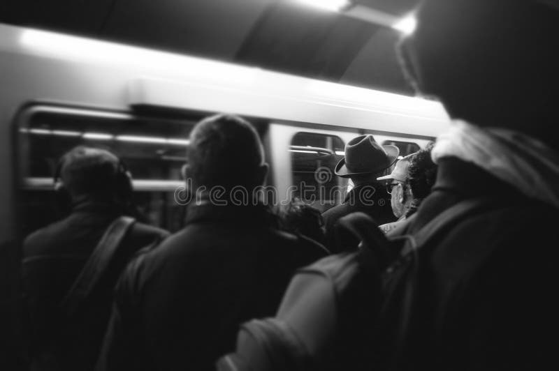Grayscale Photograph of a Crowd Standing Near a Train with Opened Doors ...