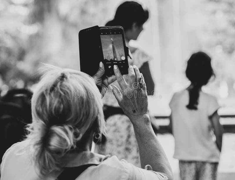 Grayscale Selective Focus Back View of a Woman Taking Picture of a ...