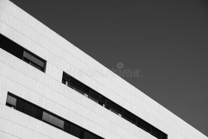 Grayscale Shot of an Abstract Building Facade on a Grey Sky Background ...