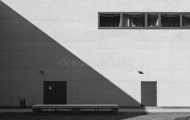 Grayscale Shot of a Brick Building Facade with Doors Stock Image ...