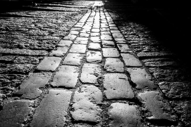 Grayscale Shot of an Empty Street with Rocks in the Evening Stock Image ...