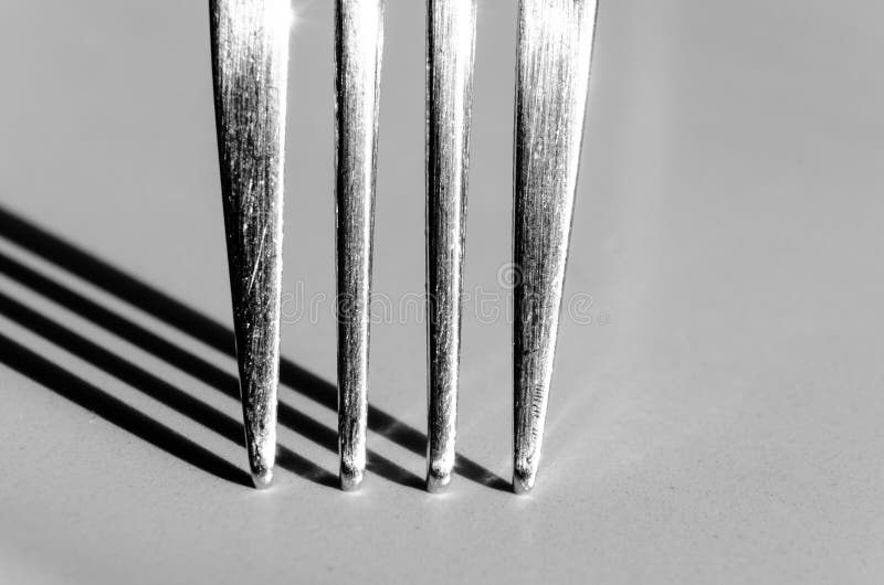 Grayscale Shot of a Fork on a Surface with a Sharp Shadow Stock Photo ...