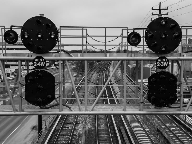 Grayscale Shot of a Train Signal Platform Over Empty Train Tracks ...
