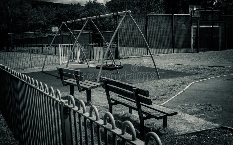 Grayscale of Swings on an Empty Playground Stock Photo - Image of ...