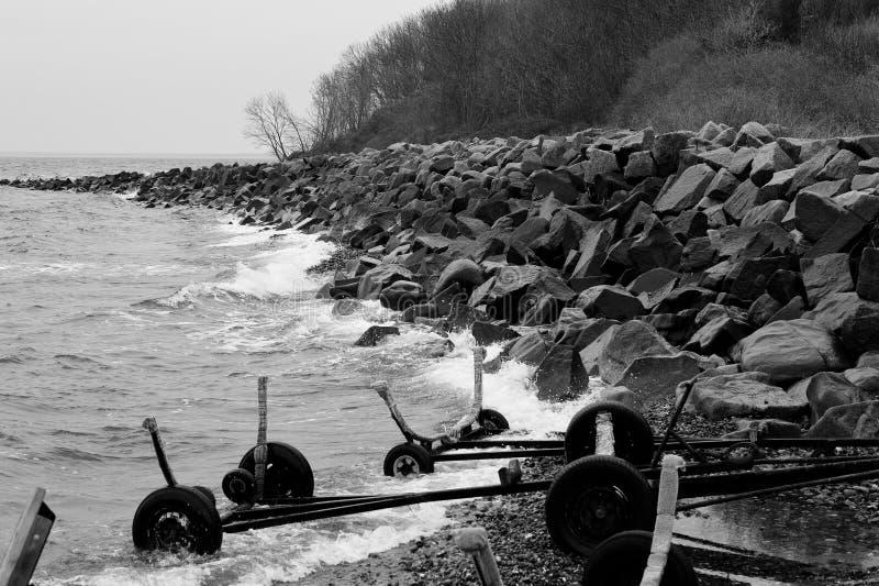 Grayscale of a Tranquil Body of Water and Rocks in the Background Stock ...