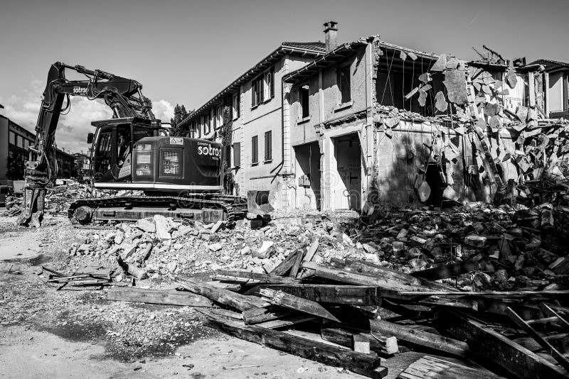Grayscale View of an Excavator Working at a Broken House Demolition ...