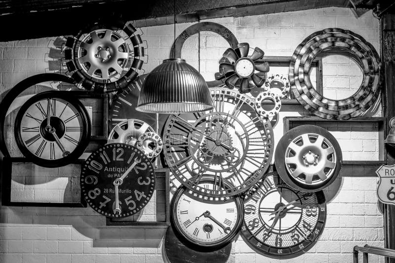 Grayscale View of a Lamp Handing before the Circle Clocks on the White ...