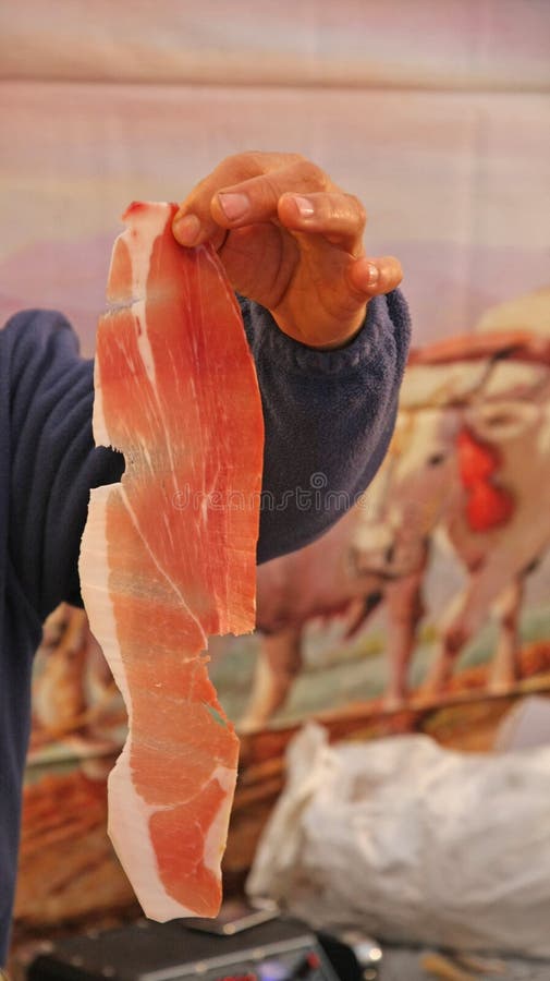Great Butcher S Hand that Holds the Big Chunk of Raw Prosciutto Stock ...