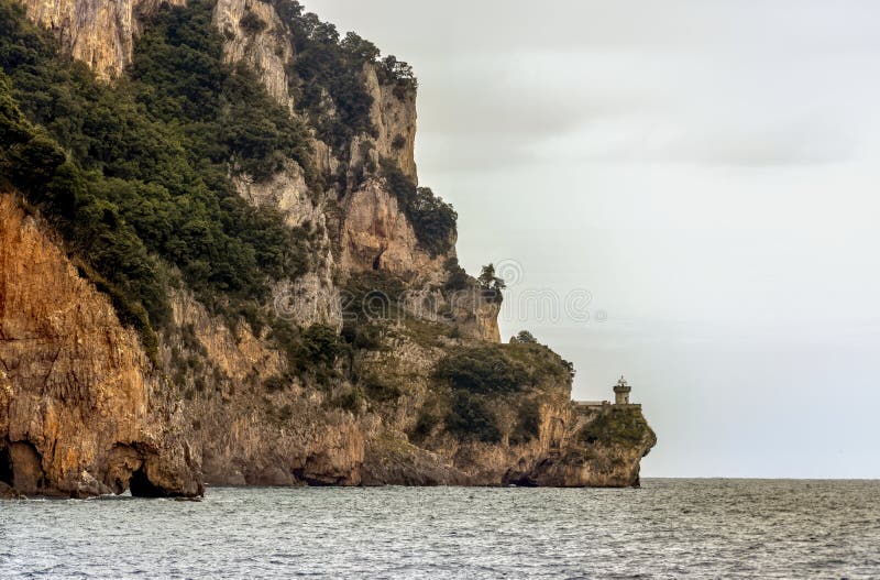 Great Cliff with a Lighthouse at Its End, Next To the Sea. Concept of ...