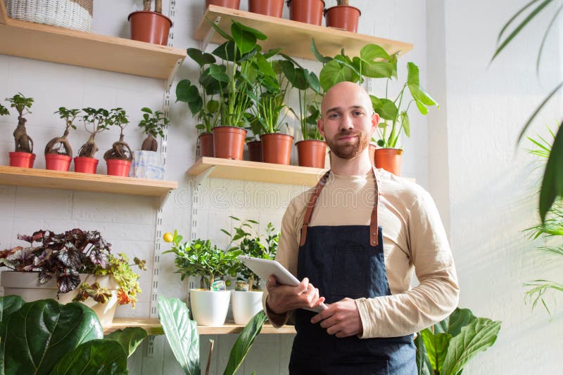 Great Looking Owner of the Floral Store Posing in Front of the Camera ...
