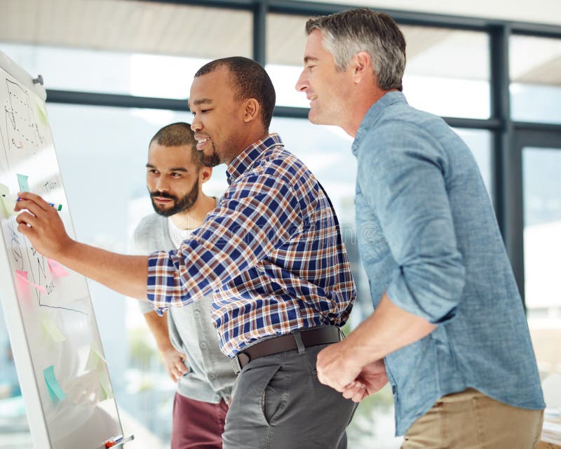 Great Minds Make the Work Easy. Three Businessmen Working at a ...