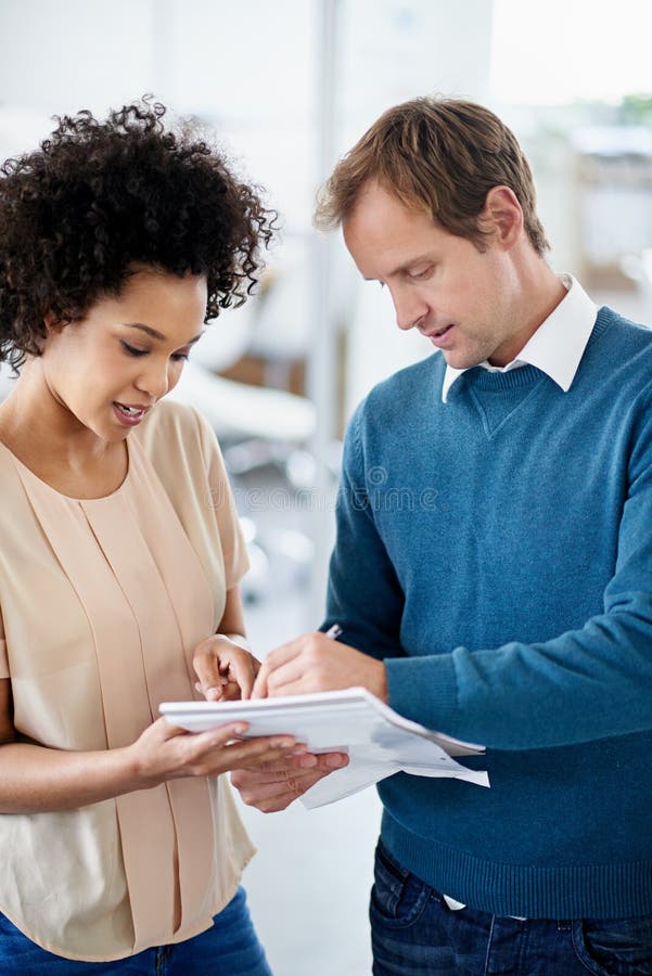 Great Minds Think Alike. Two Colleagues Discussing Ideas on a Notepad ...
