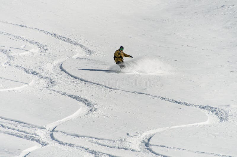 Great View of a Snow-covered Mountain Slope and a Man on a Snowboard ...