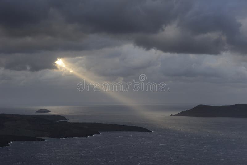 Greece. Piercing Sunbeam Over Santorini Island Stock Photo - Image of ...