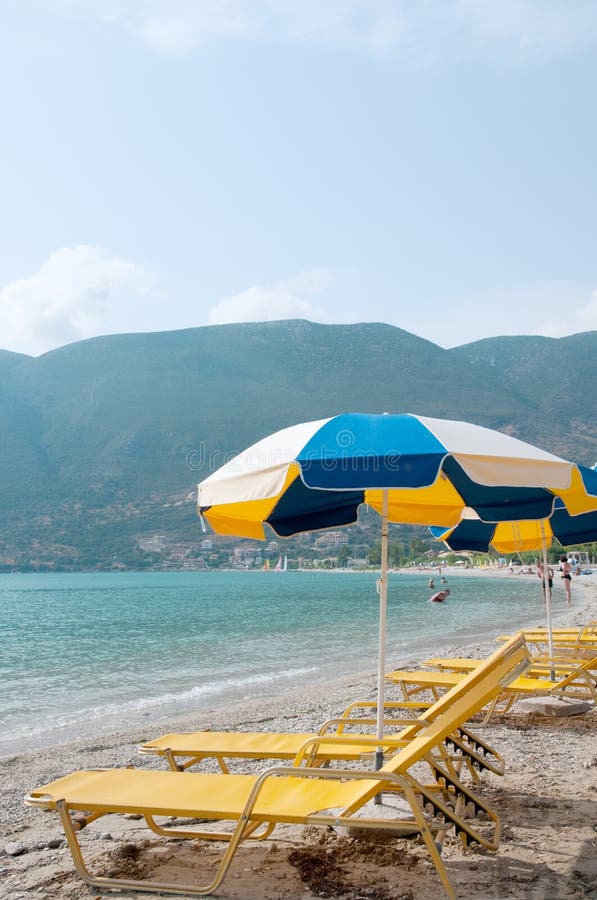 Greek beach with man stock image. Image of water, sitting - 18677939