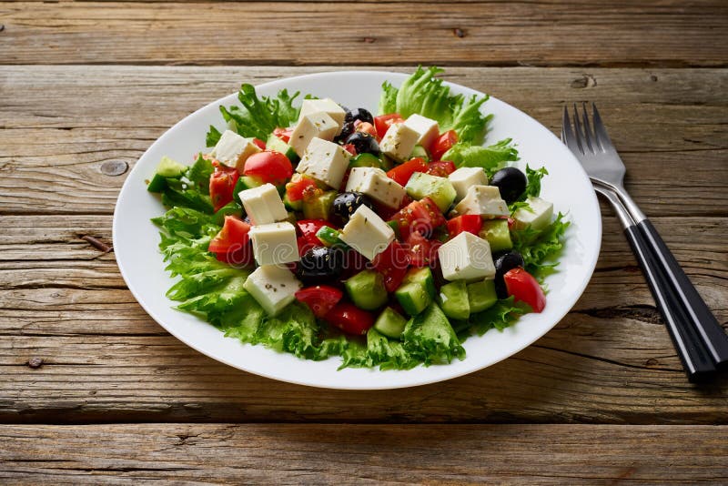 Greek Salad on White Plate on Old Rustic Wooden Table, Side View Stock ...