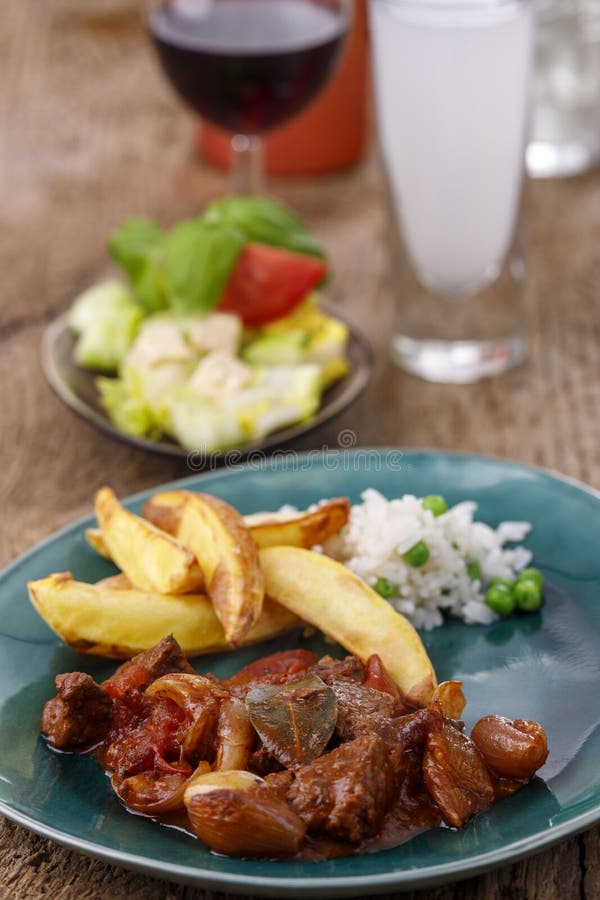 Greek stifado meat stew stock image. Image of white - 264902477