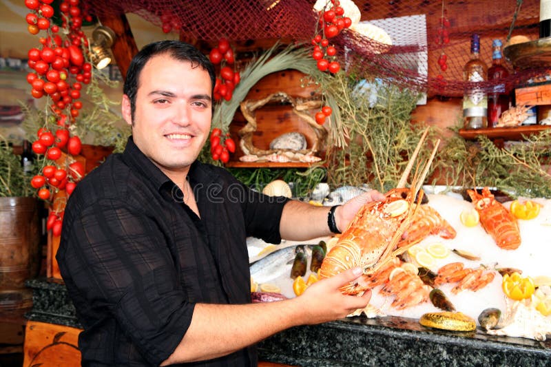 Greek waiter with lobster stock image. Image of taverna - 5352977