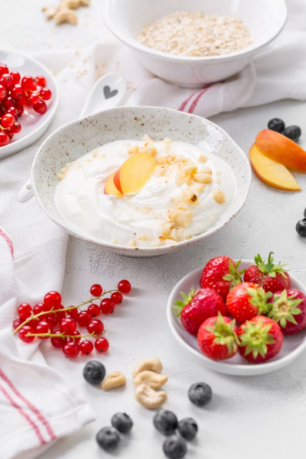 Greek Yogurt with Assorted Berries, Nuts and Oat Flakes Stock Photo ...