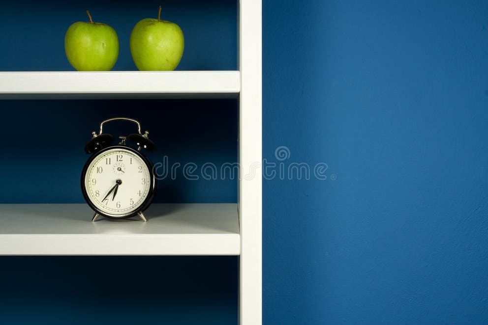 Green Apple and Clock Inside White Bookcase Stock Photo - Image of ...