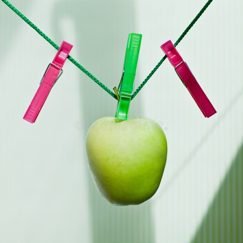 Green Apple Hanging on the Rope with Clothespins Stock Image - Image of ...
