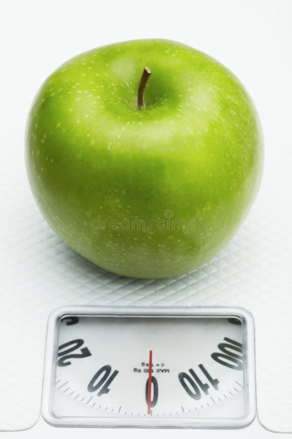 Green Apple on a Weighing Scale Stock Photo - Image of organic, still ...
