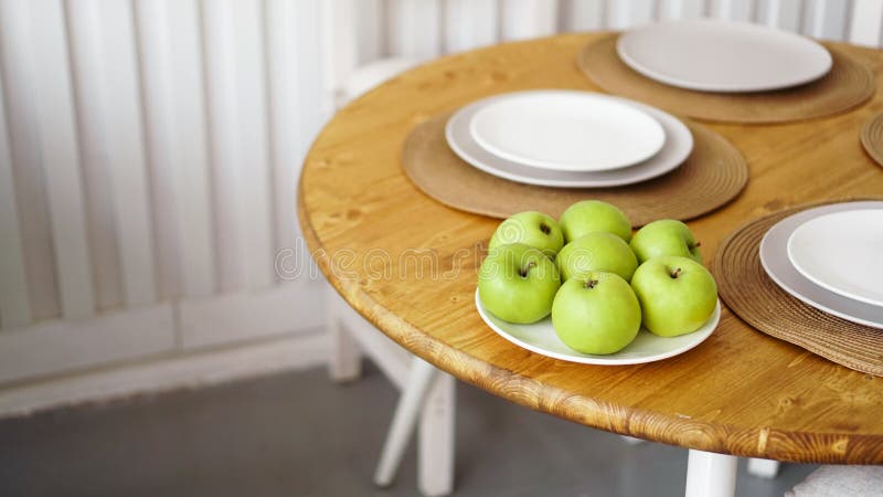 Green Apples on a White Plate on a Wooden Table. White Scandinavian ...
