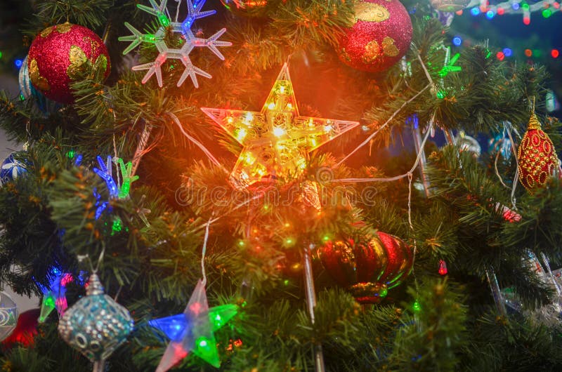 Green Artificial Christmas Tree with a Multi-colored Garland Stock ...