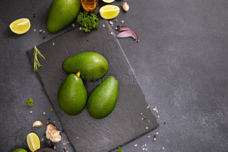 Green Avocado on Stone Serving Board Stock Photo - Image of table ...