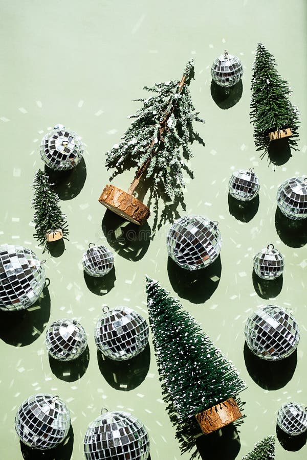 Green Background with Artificial Christmas Trees and Many Shiny Disco ...